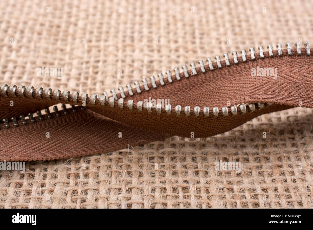 Parts of the brown color zipper on linen canvas background Stock Photo ...