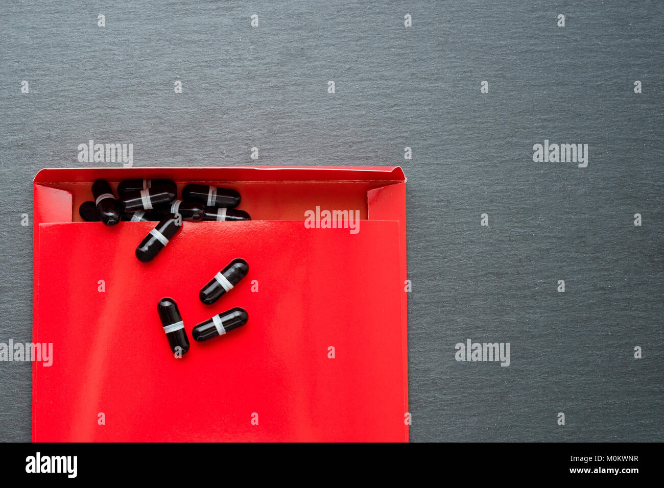 Pharmaceutical medicine and supplement with black capsules in package ...