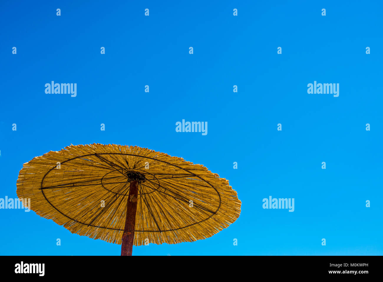 Exotic straw parasol on a beach Stock Photo - Alamy