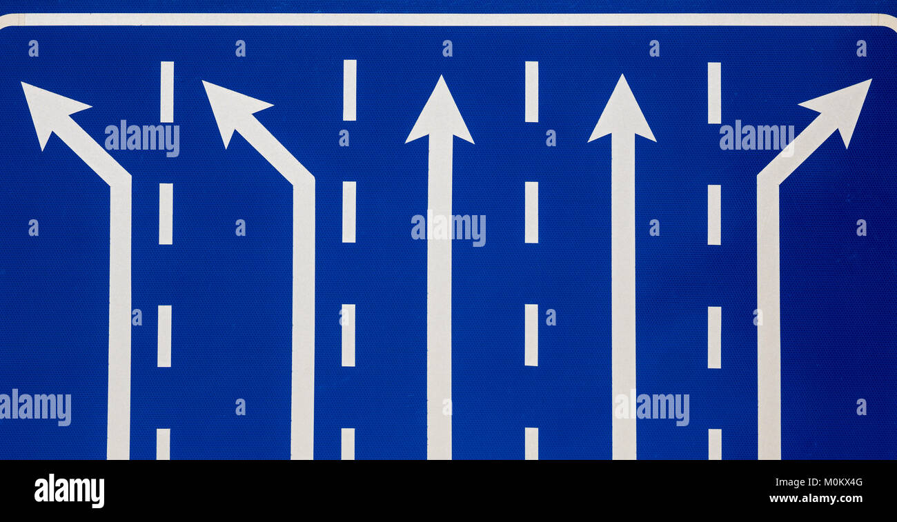 Blue road sign indicating traffic direction Stock Photo - Alamy