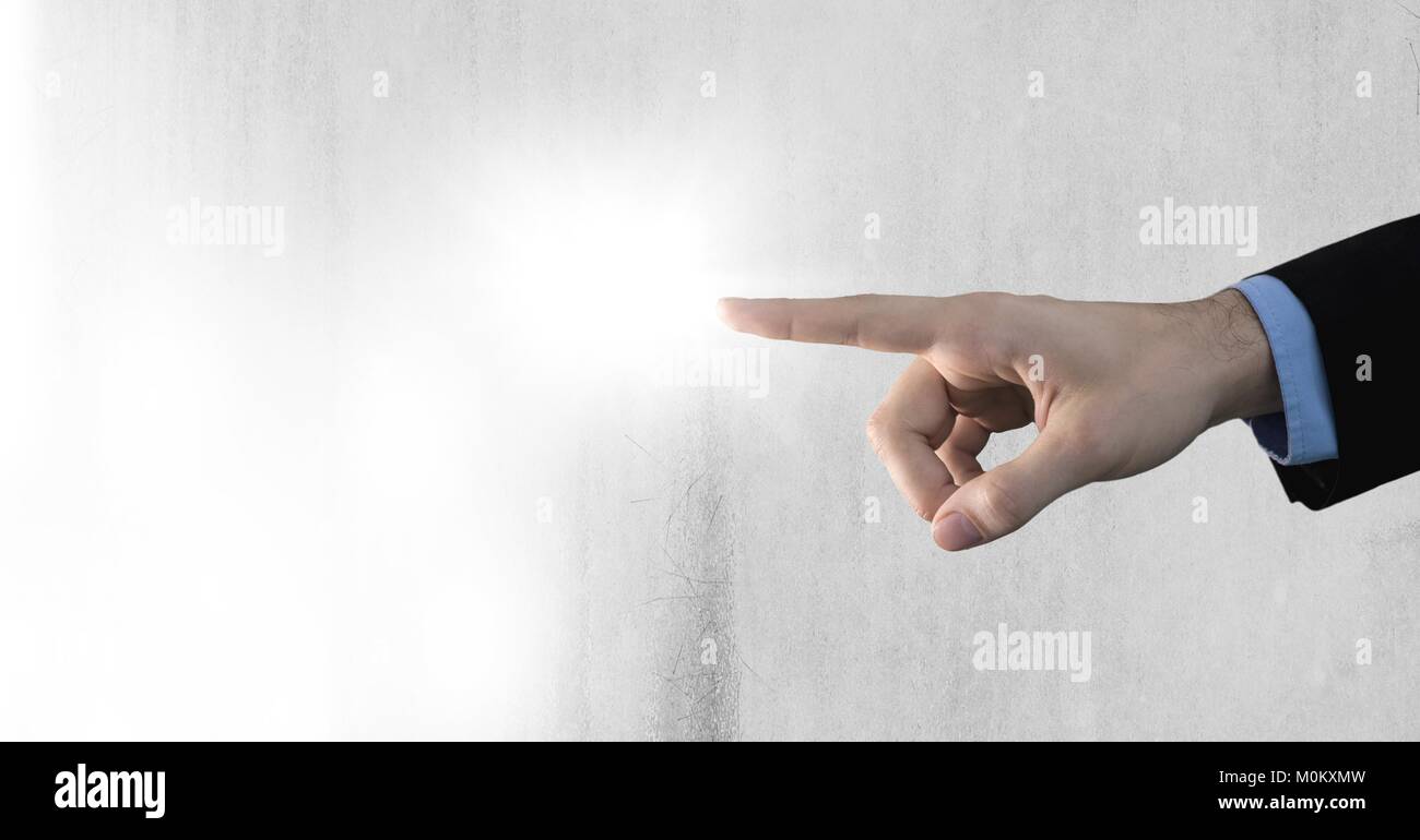 Hand pointing with grey background Stock Photo - Alamy