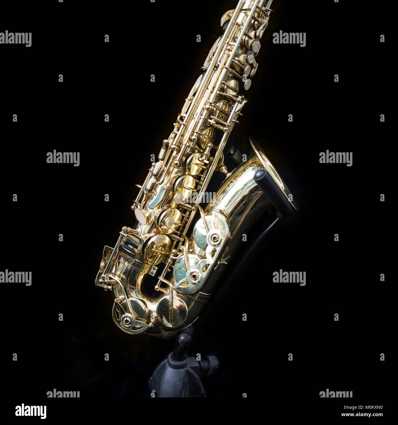 Close up of a standing golden saxophone isolated in black Stock Photo ...
