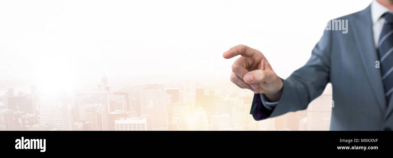 Hand pointing with businessman over city Stock Photo - Alamy