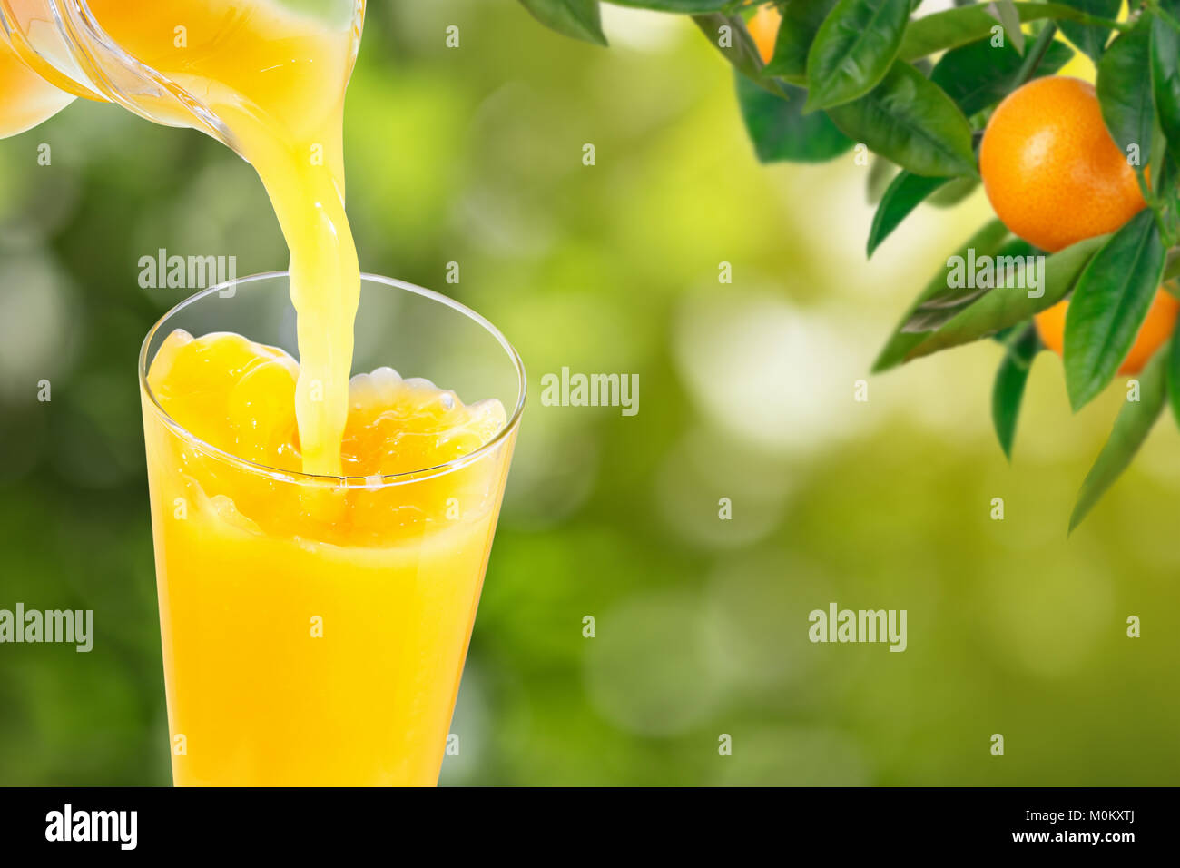 pouring orange juice Stock Photo - Alamy