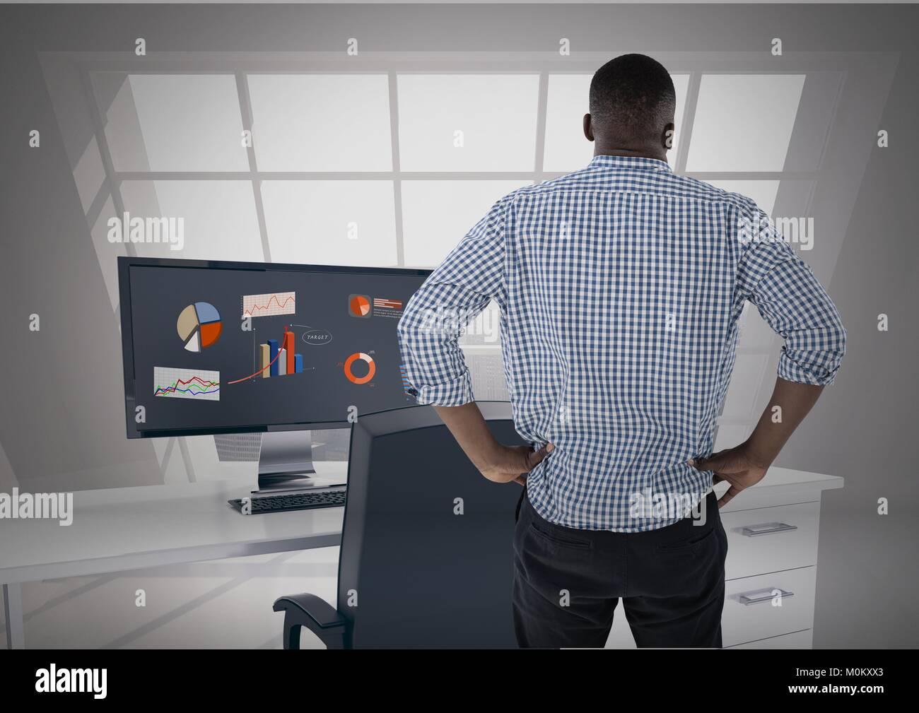 Man facing away looking out office window while data is on computer ...