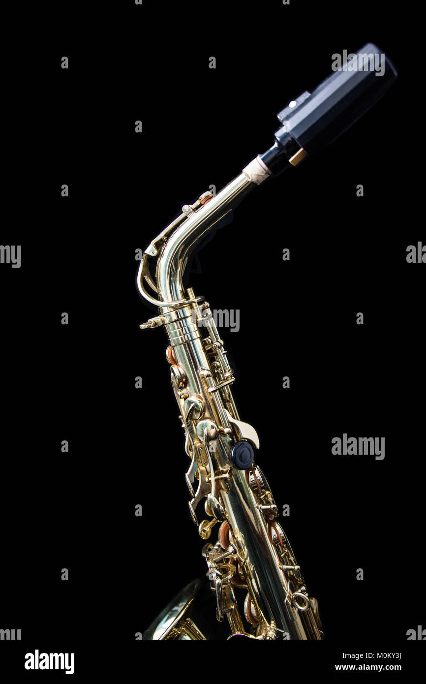 Close up of a standing golden saxophone isolated in black Stock Photo ...