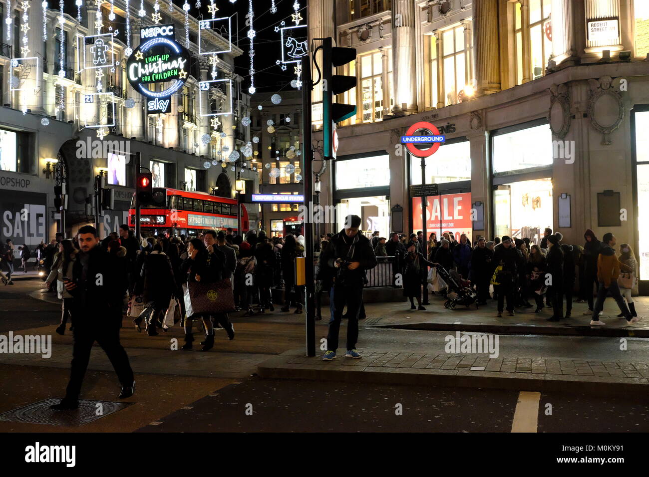 lluminated Underground sign on a busy London street at night Stock ...