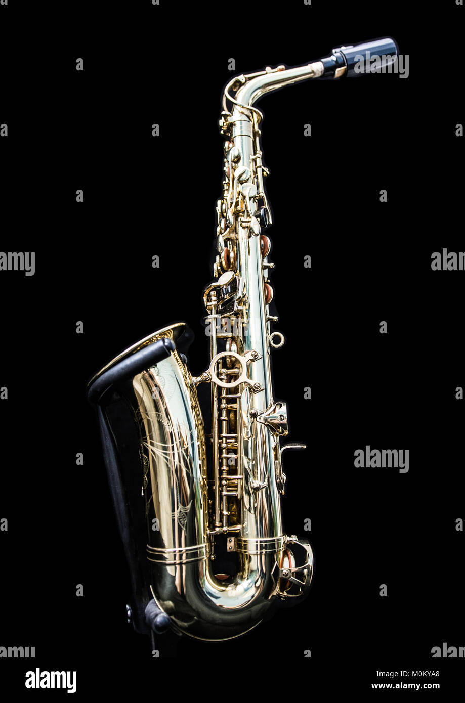 Close up of a standing golden saxophone isolated in black Stock Photo ...