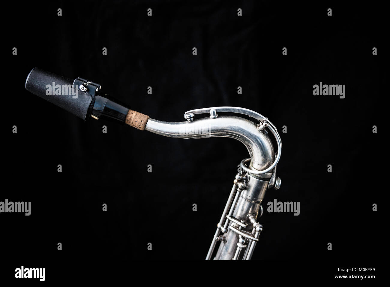 Close up of a silver saxophone standing isolated in black Stock Photo ...