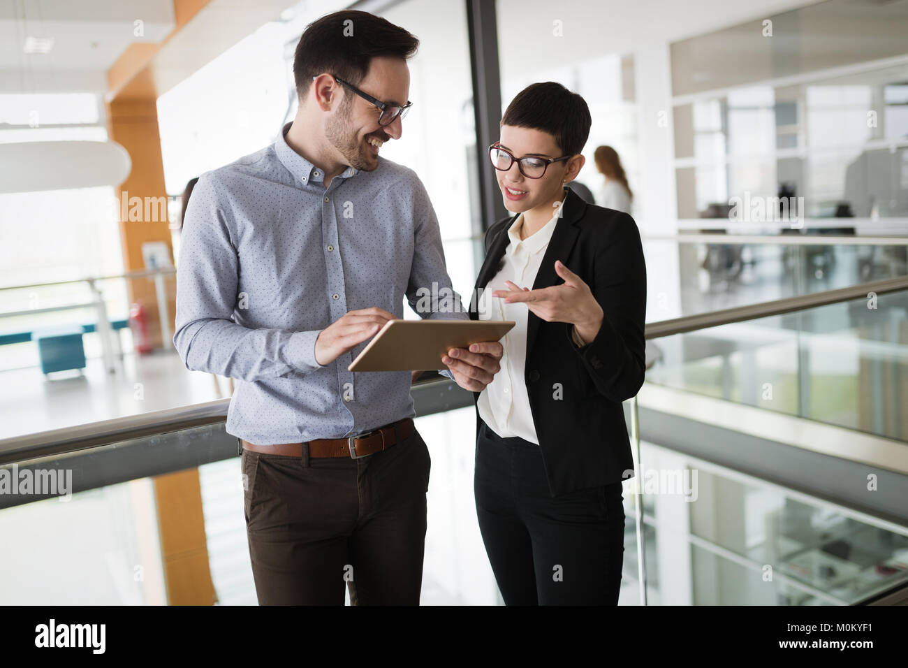 Corporate teamworking colleagues in modern office Stock Photo - Alamy