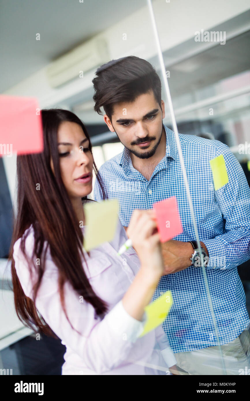 Businesswoman using sticky notes at office to plan project Stock Photo ...