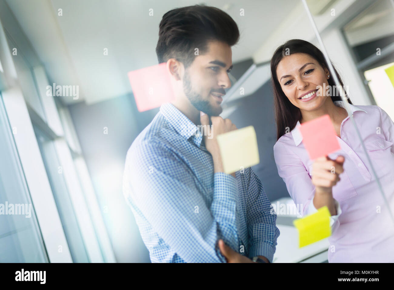 Businesswoman using sticky notes at office to plan project Stock Photo ...