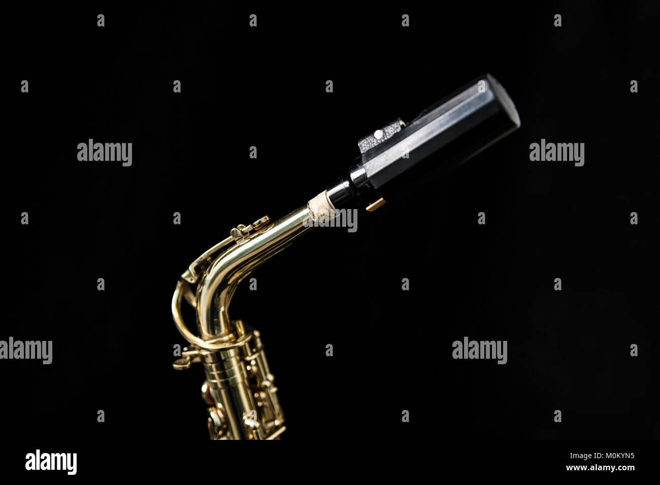 Close up of a standing golden saxophone isolated in black Stock Photo ...