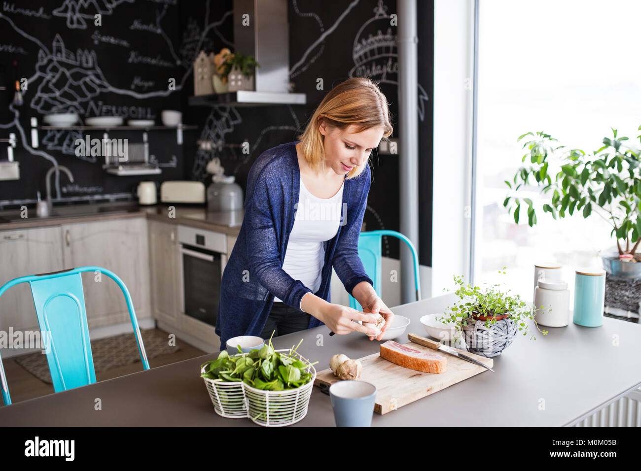 Young woman cooking at home Stock Photo - Alamy