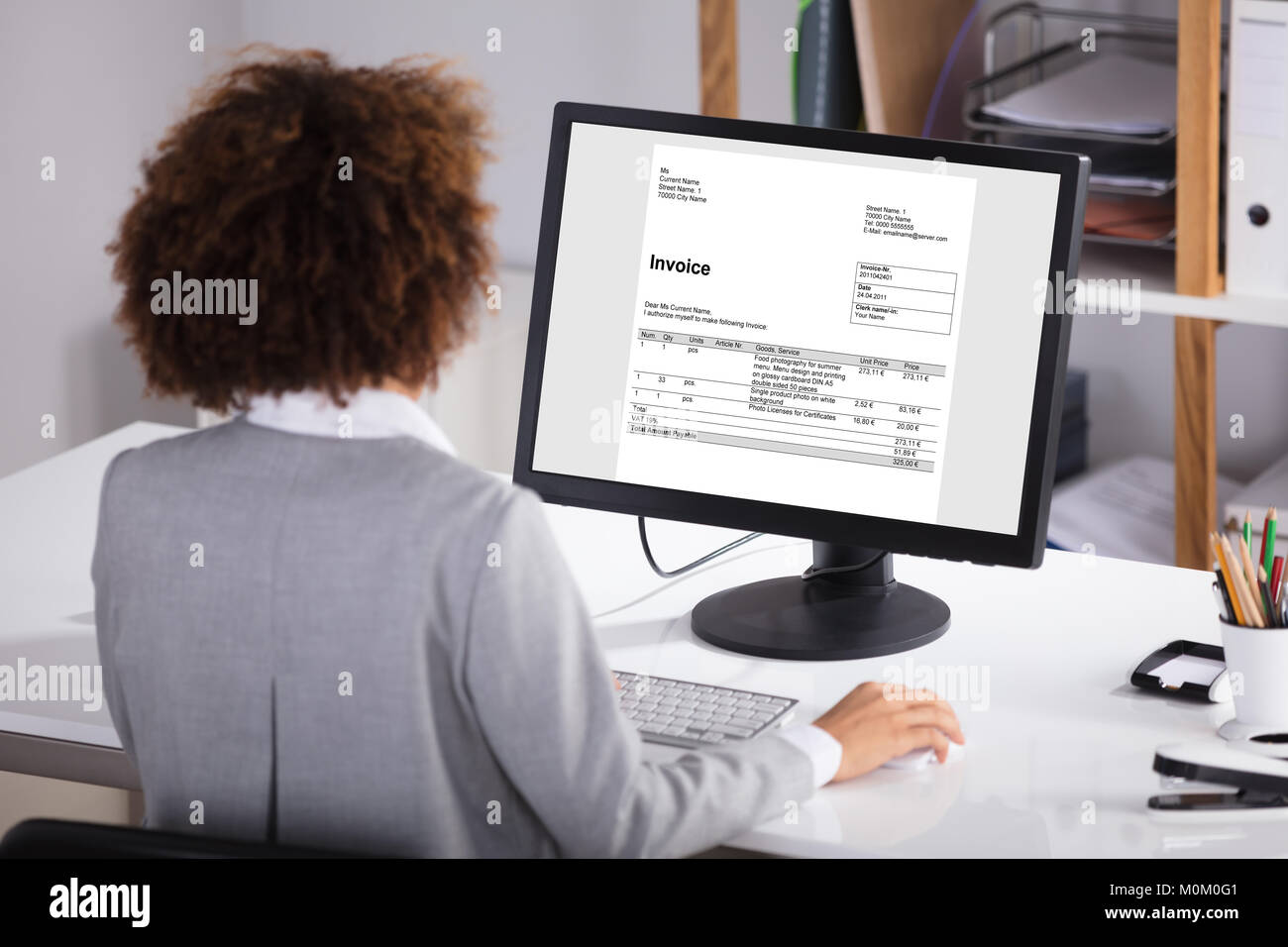Businessperson Working On Computer With Invoice On Computer Screen In ...