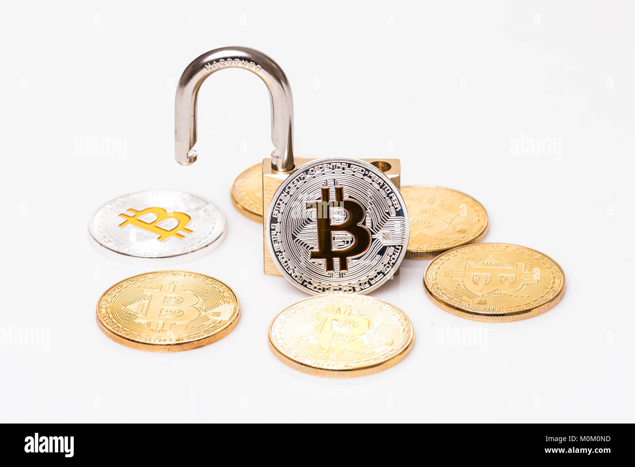 Many bitcoins with a open lock isolated white Stock Photo - Alamy
