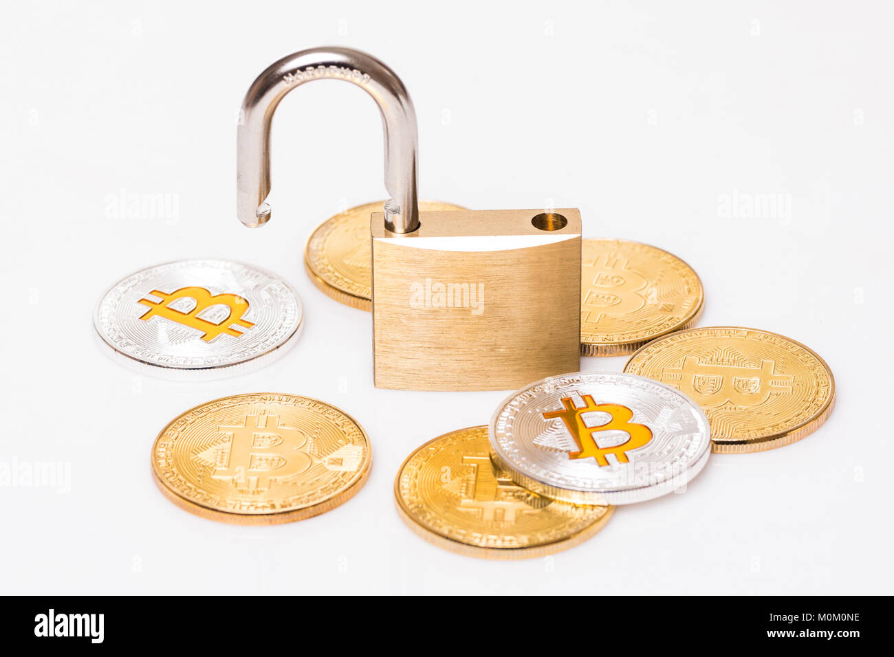 Many bitcoins with a open lock isolated white Stock Photo - Alamy