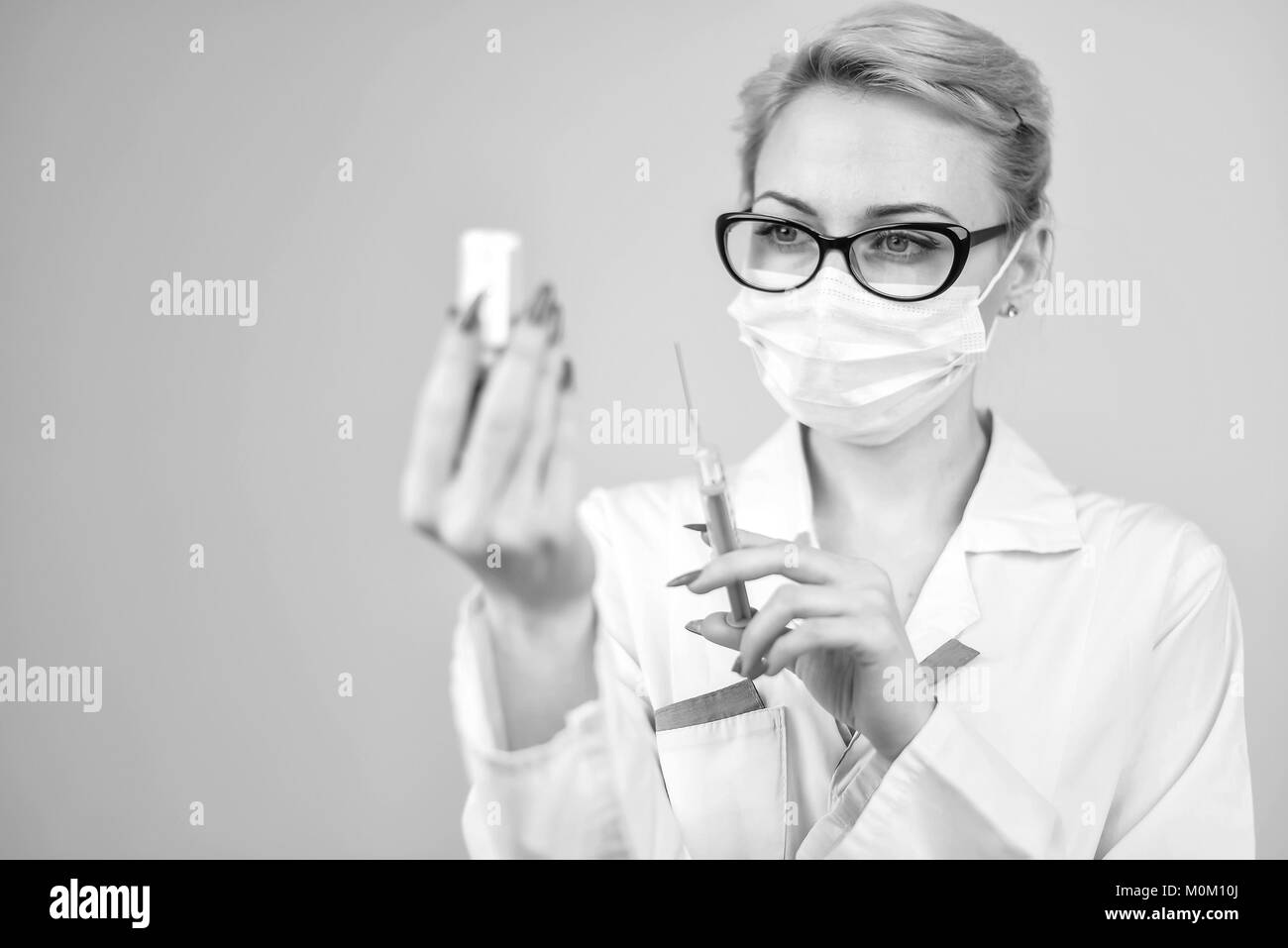 Doctor in his medical office at work black and white poster Stock Photo ...
