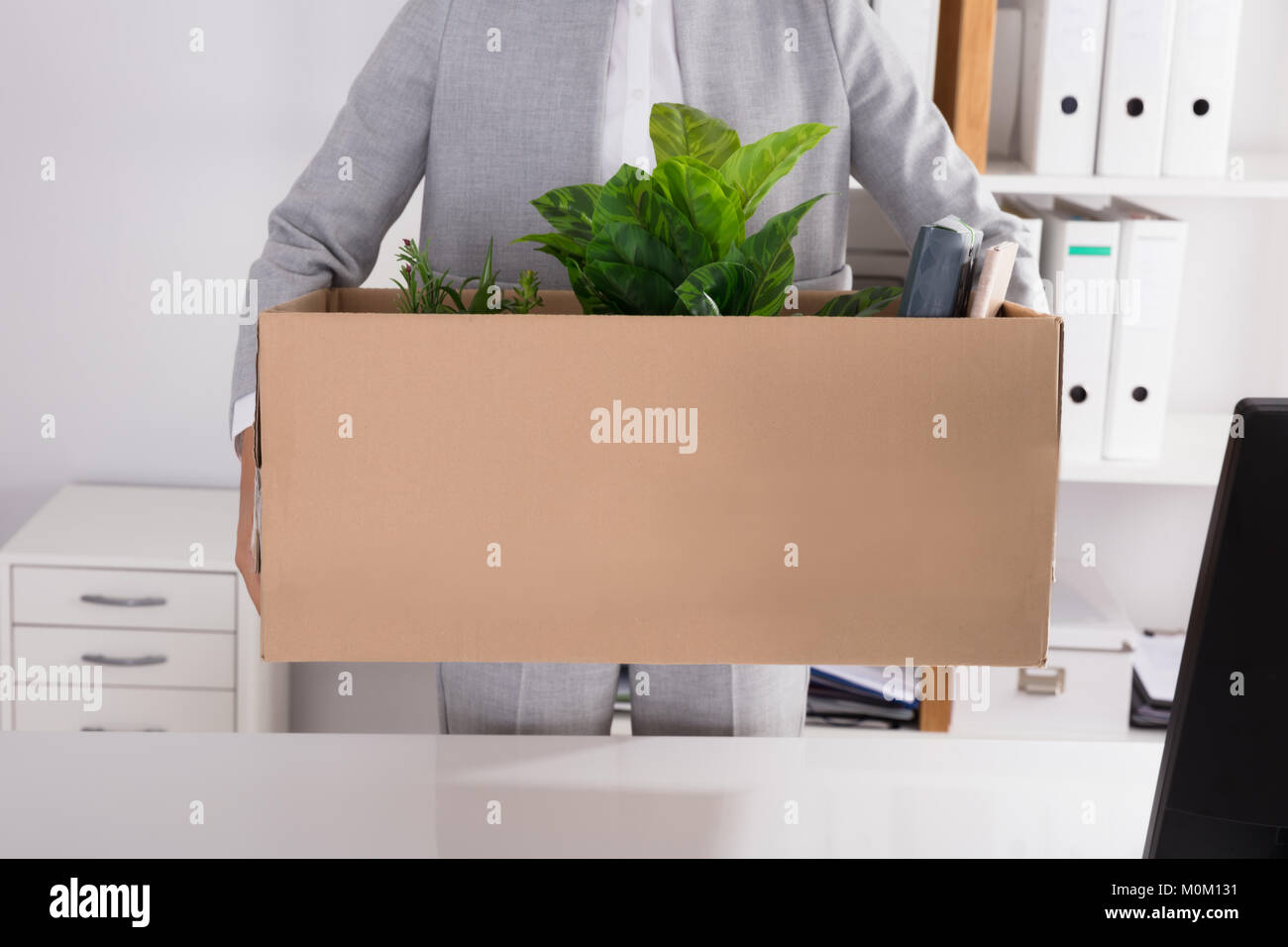Mid Section View Of A Businessperson Carrying Cardboard Box With ...