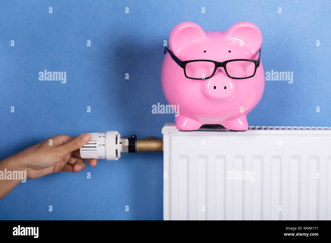 Person Hand Adjusting Temperature On Thermostat To Save Money On Energy ...