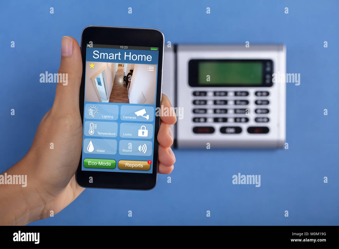 A Person Holding Mobile Phone With Home Security Application In Front ...