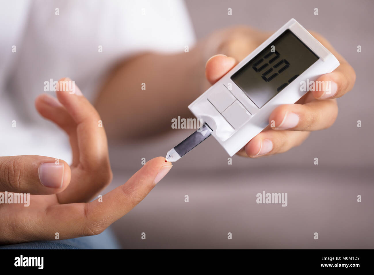 Close-up Of A Person's Hand Checking Sugar Level With Glucometer Stock ...