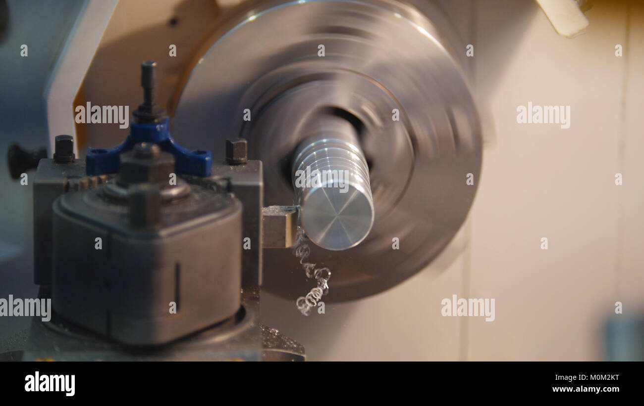 Threading of metal parts on the lathe machine at the factory, lots of ...