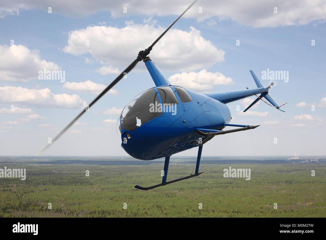The aircraft - the small Blue Helicopter flight sky and clouds ...
