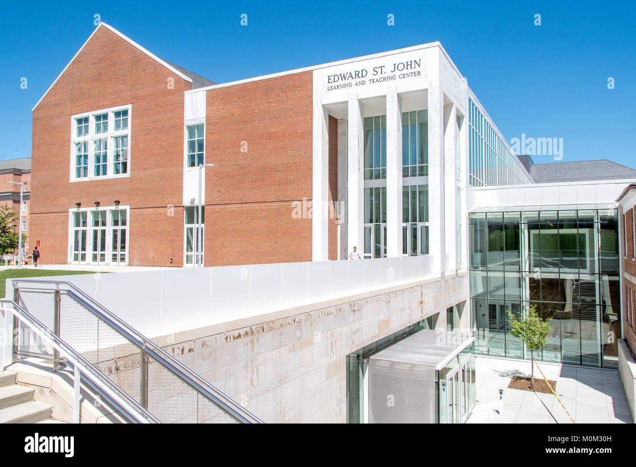 Exterior of brick building with tall marble columns and large glass ...