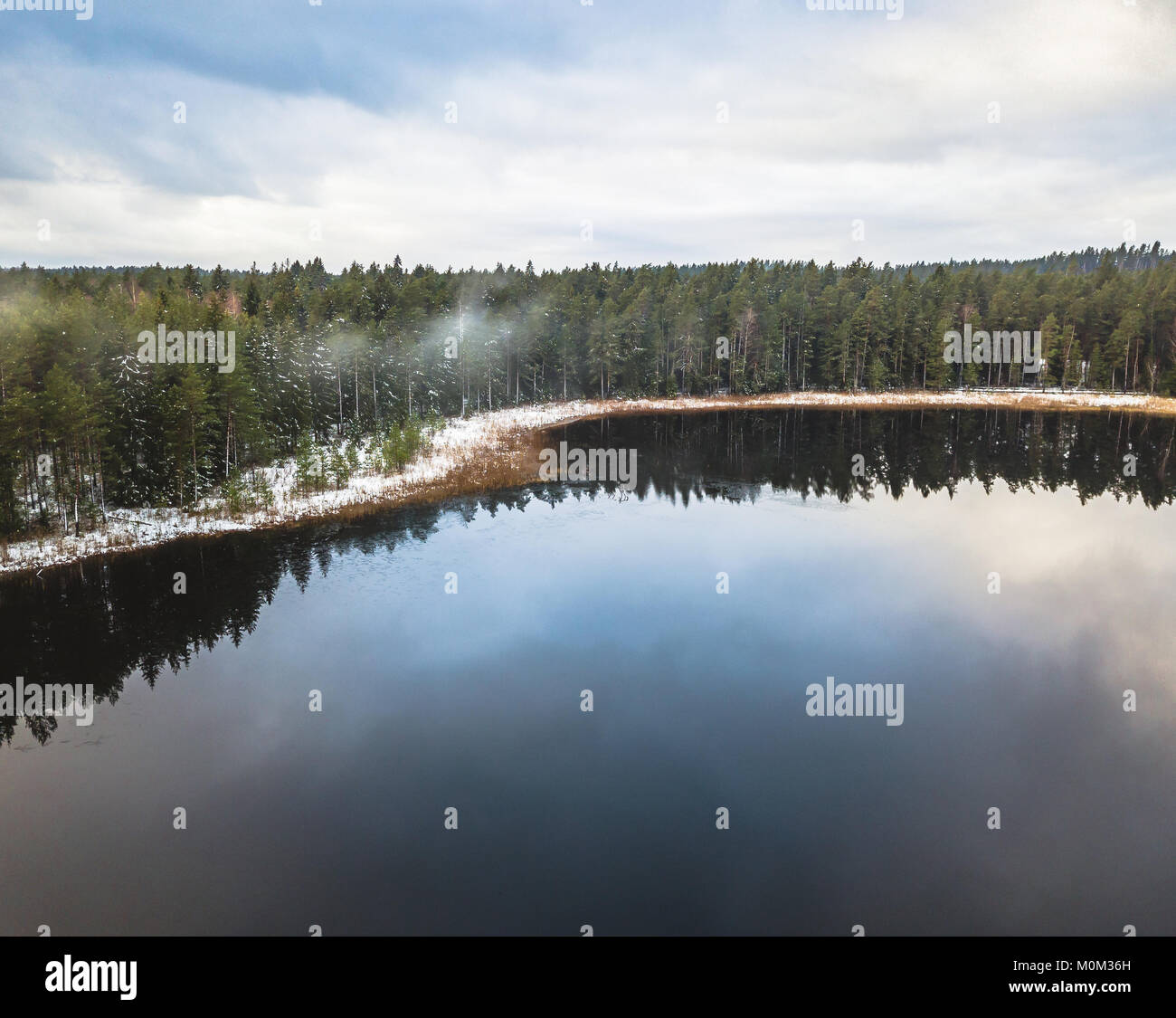 Aerial Drone Photograph of a Partly Frozen Lake in a Snowy Winter Day ...
