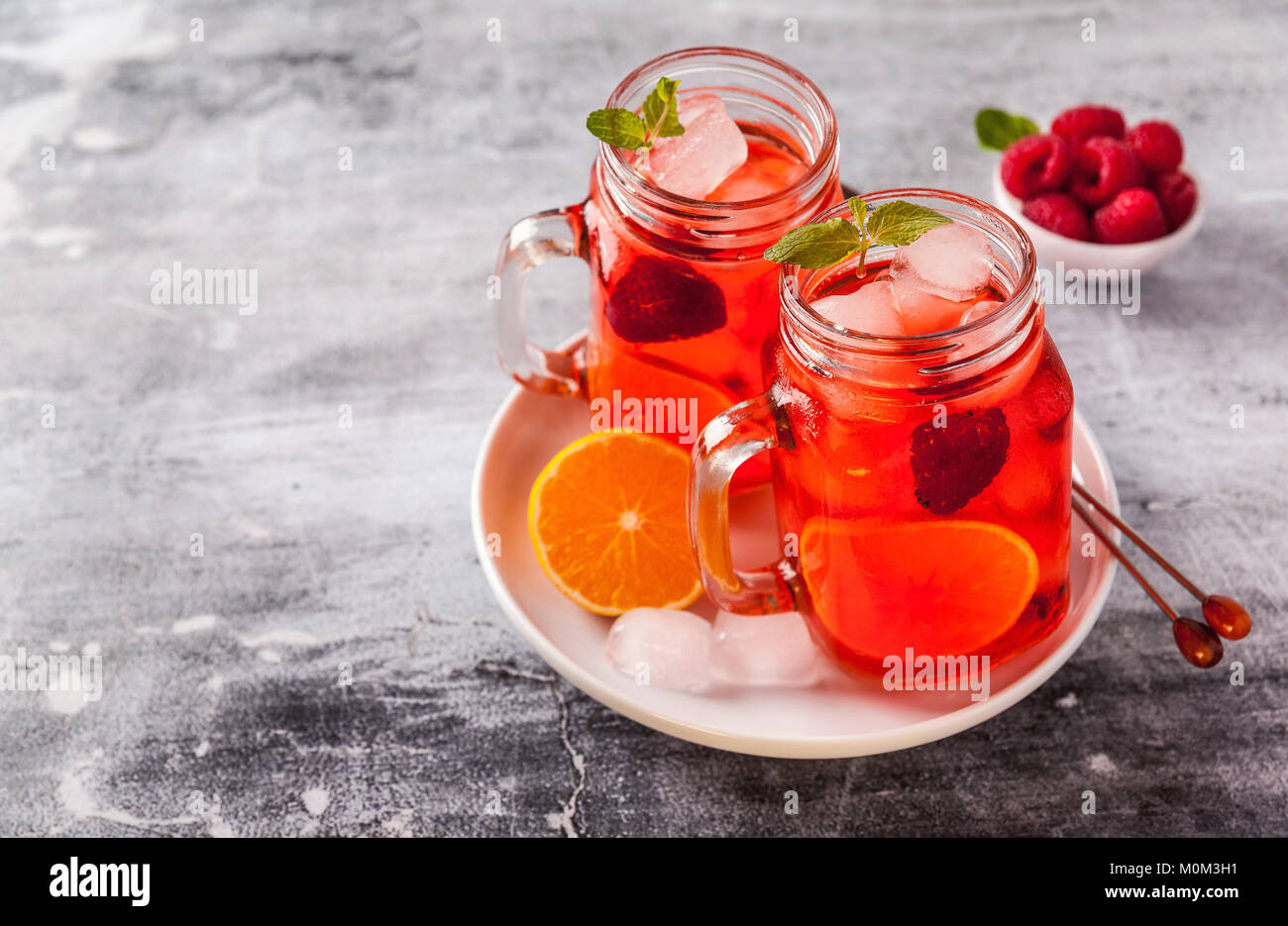 summer refreshing drink with ice and fresh ripe berries. raspberries ...