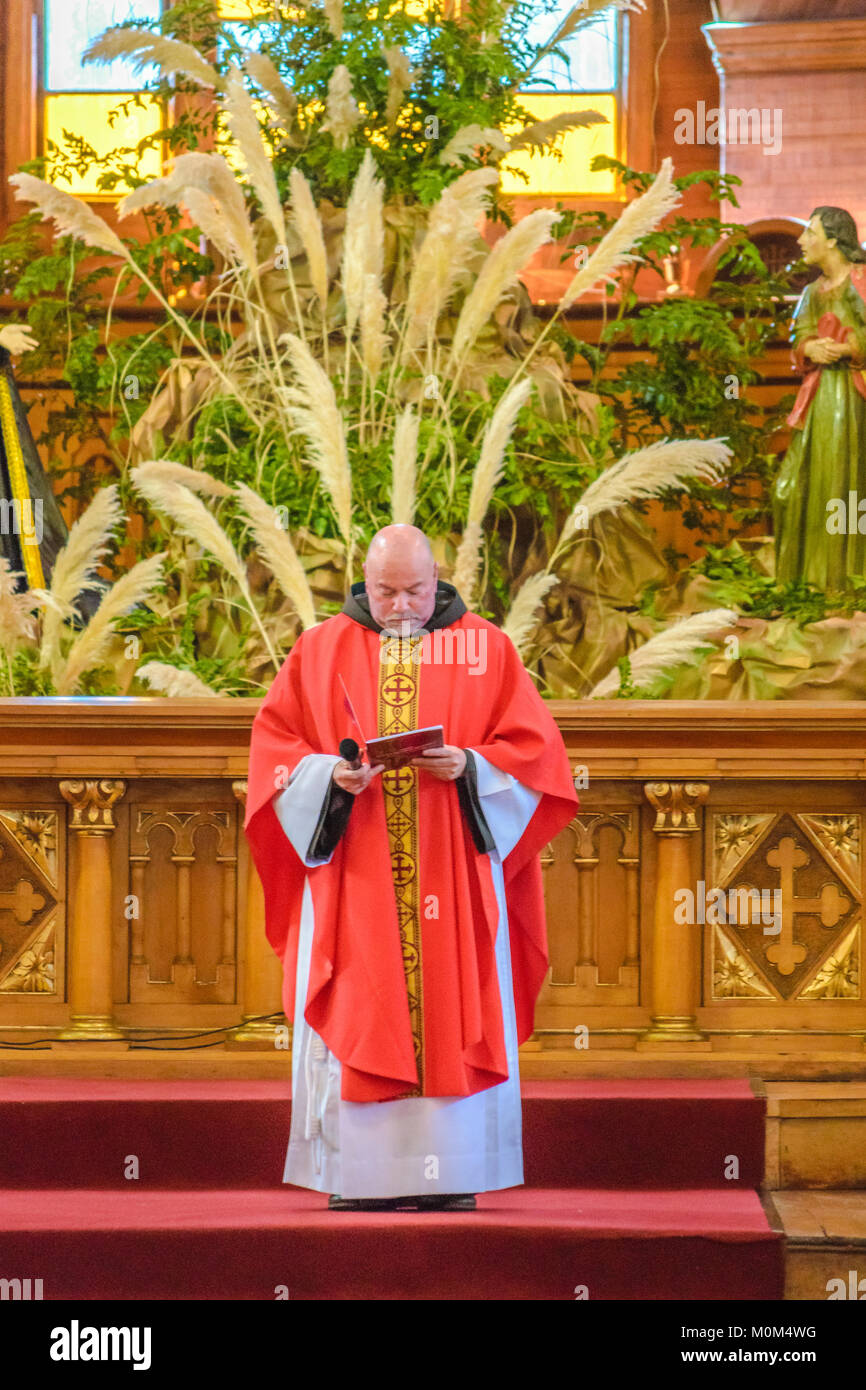 CHILOE, CHILE, APRIL - 2017 - Priest giving the mass at inside of ...