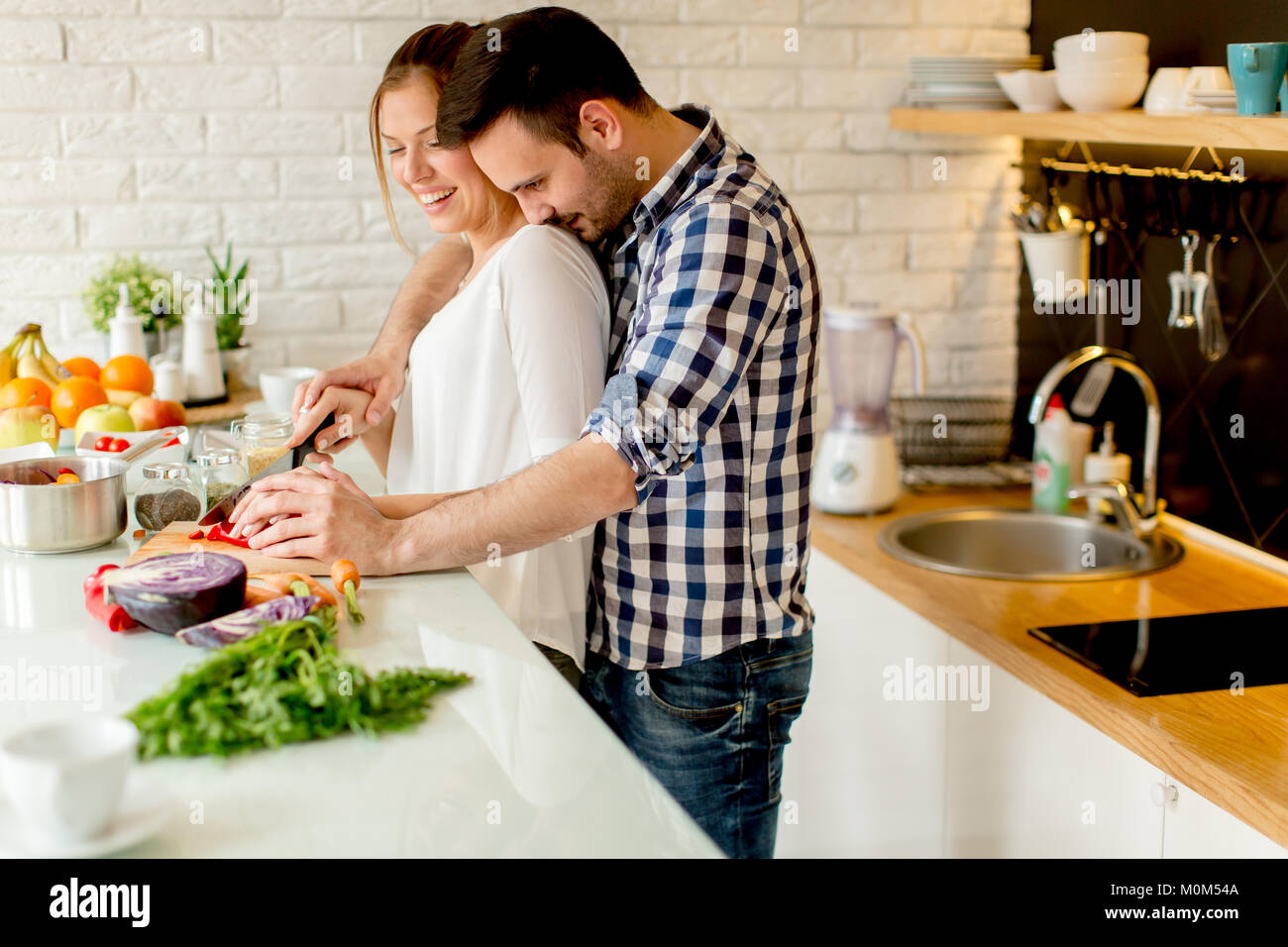 Lovely Young Couple Preparing Healthy Meal In The Modern Kitchen Stock
