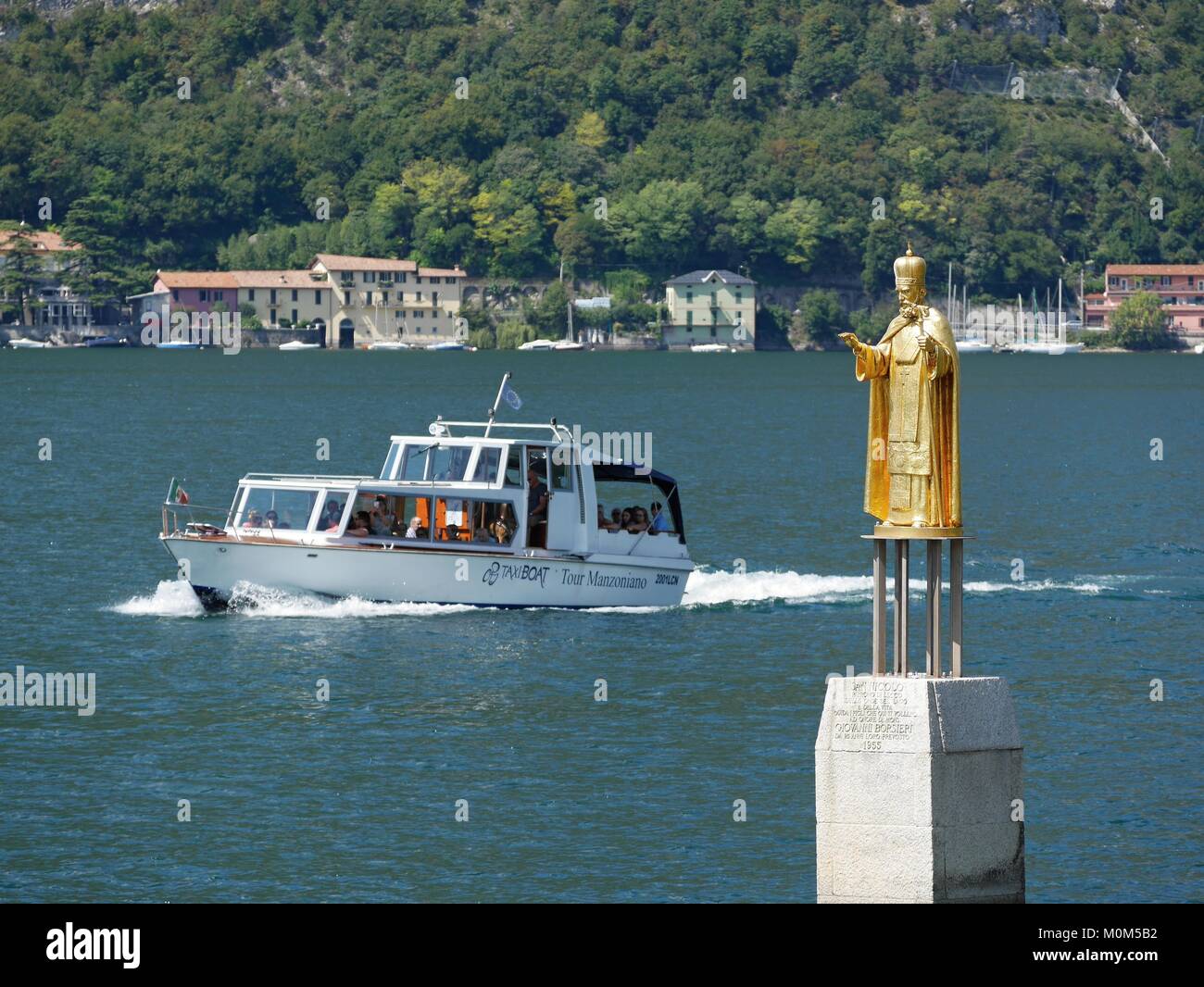 Golden statue of Saint Nicholas on Lake Como, Lecco, Italy Stock Photo ...