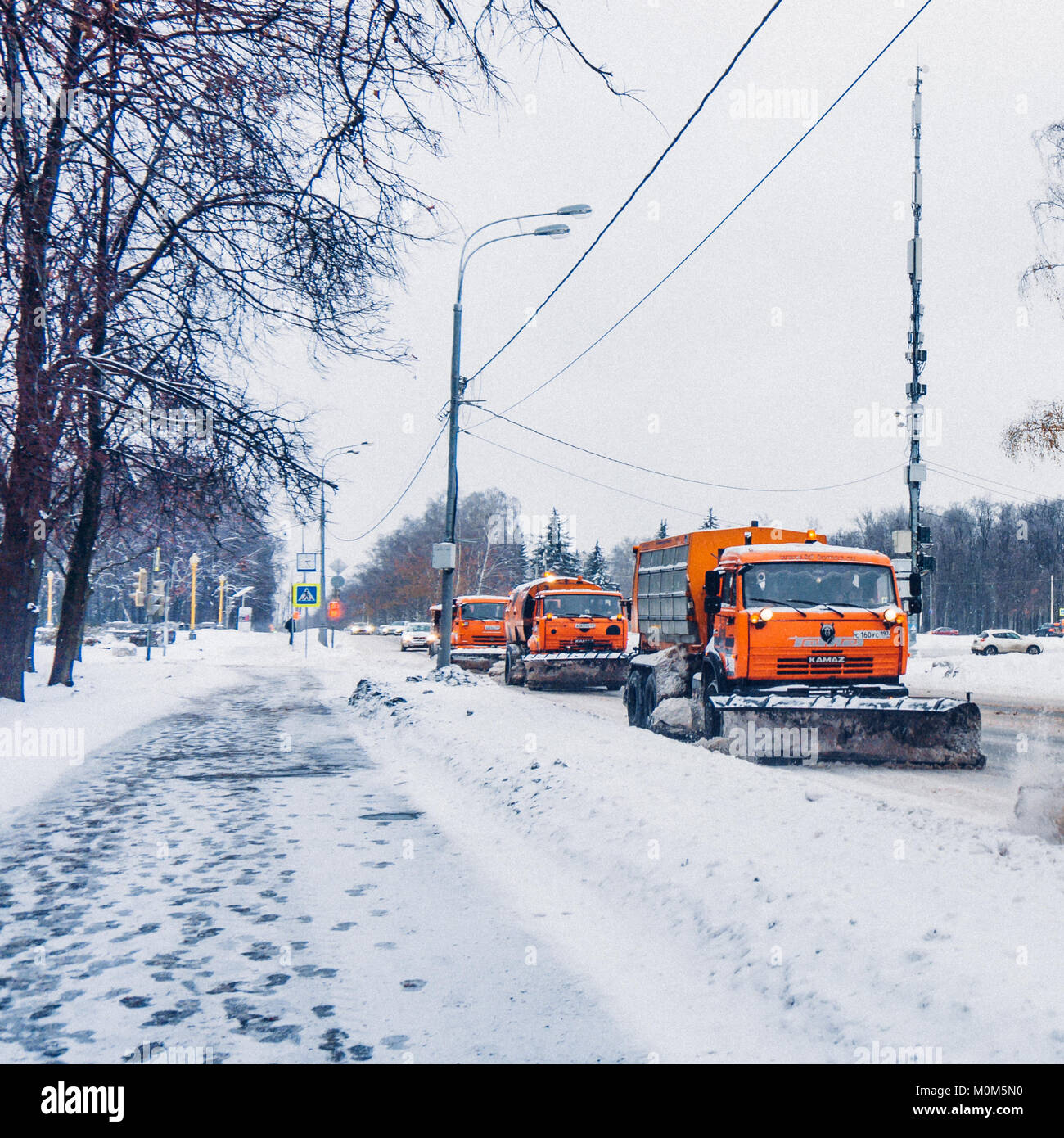 MOSCOW, RUSSIA - NOVEMBER 22, 2016: Snowplow cleans from the road snow ...