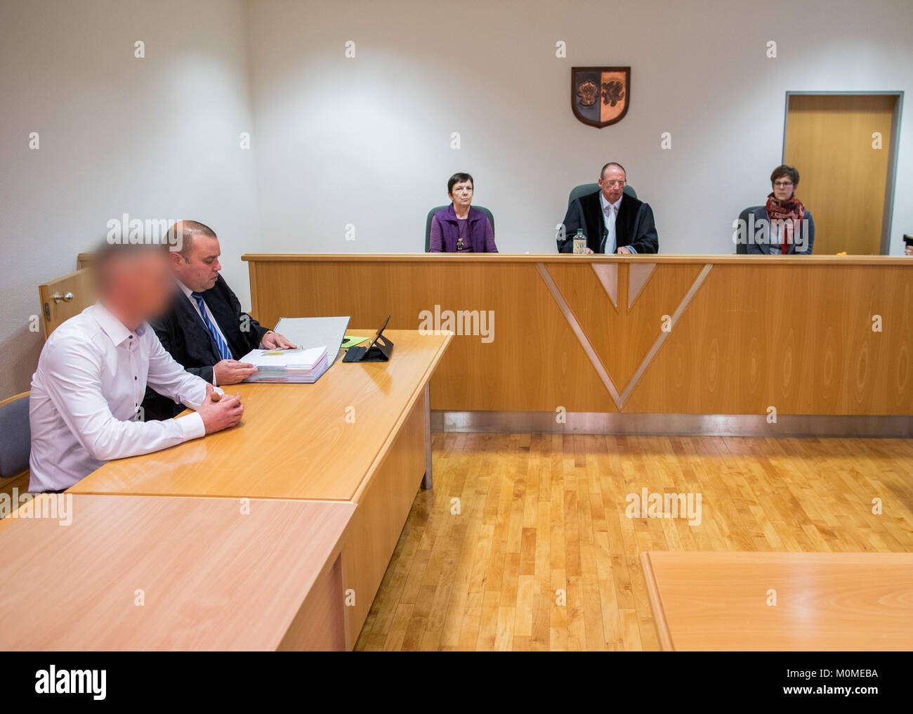 The defendant (L) sits next to his lawyer Benjamin Richert (2-L) at the ...