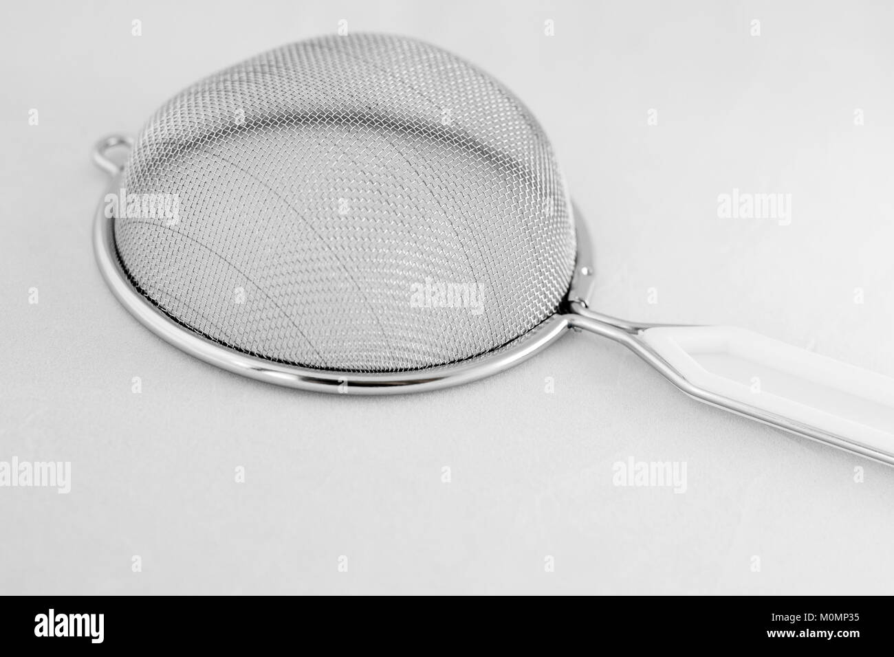 A kitchen strainer on white background Stock Photo - Alamy
