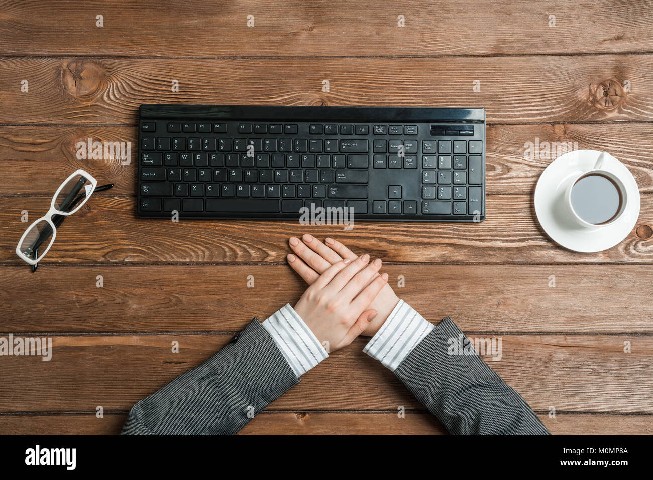 Top view of woman sitting at table with hands folded Stock Photo - Alamy