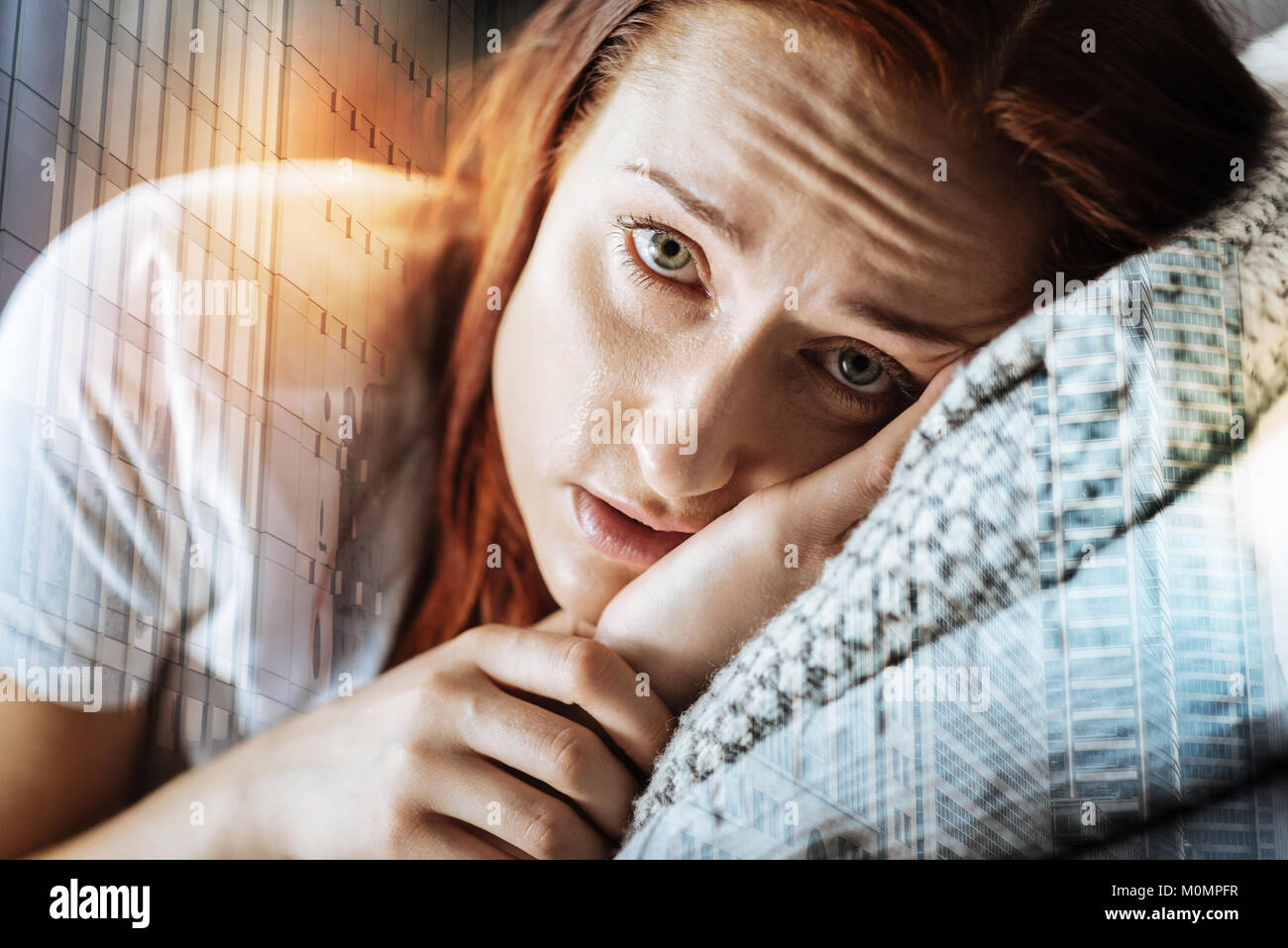 Sad thoughtful lady holding hands under head and lying Stock Photo - Alamy