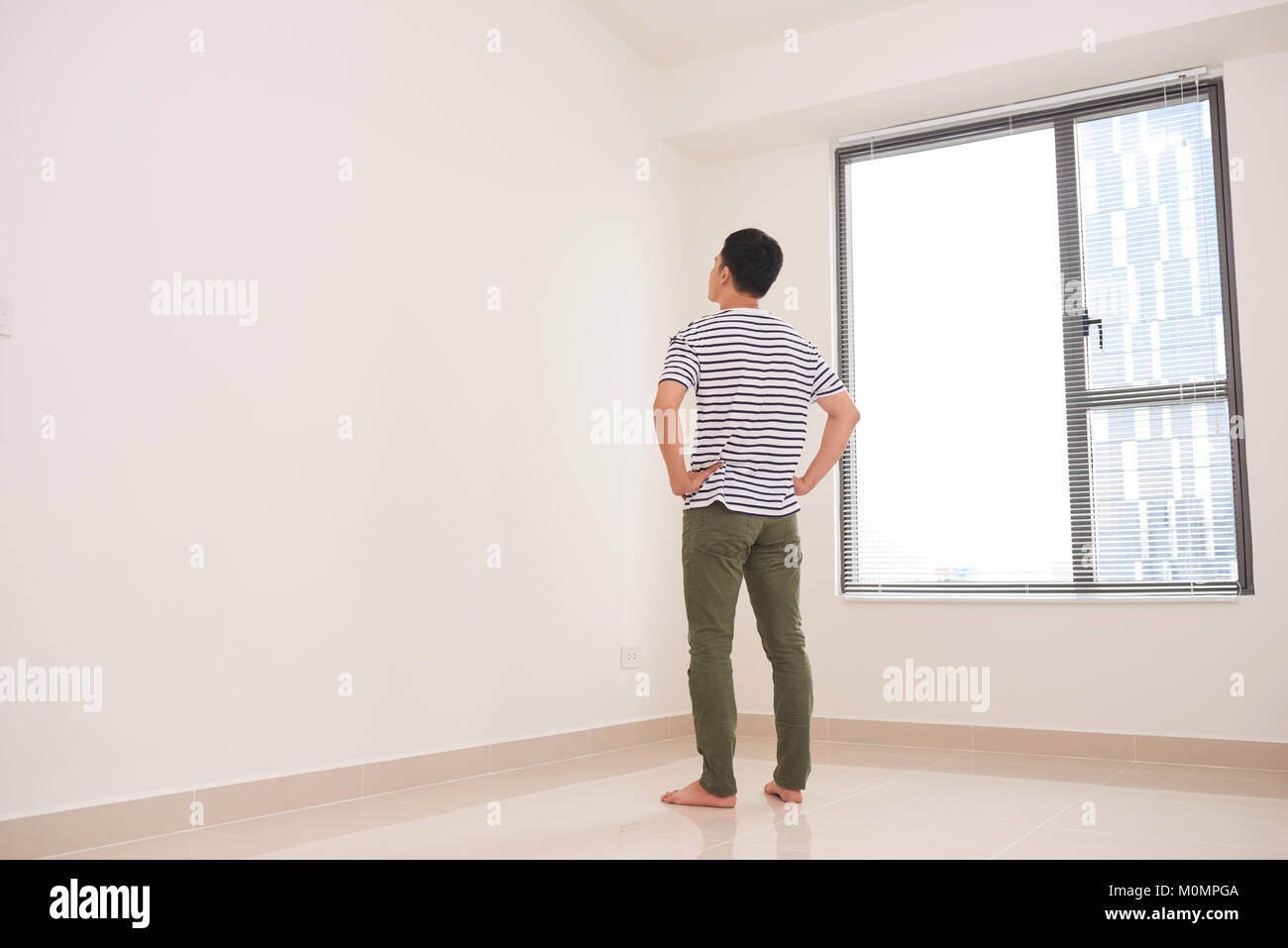 A man stands in his empty apartment Stock Photo - Alamy