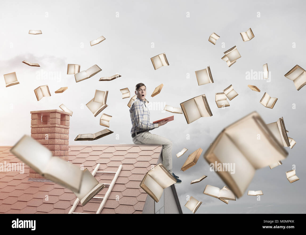 Man reading book and many of them flying in air Stock Photo - Alamy