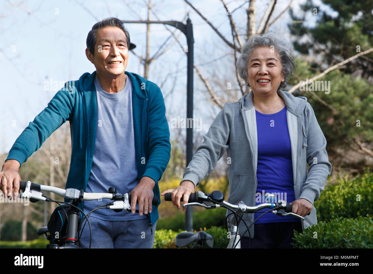 Outdoor riding bicycle for old couple Stock Photo - Alamy