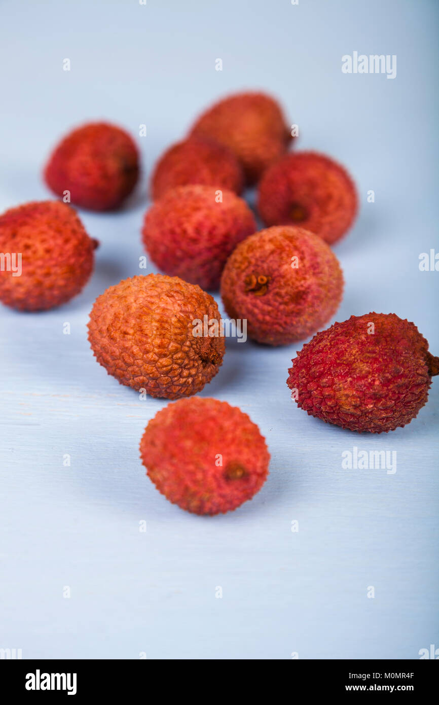 Lychee on a blue table. Delicious tropical fruit Stock Photo - Alamy