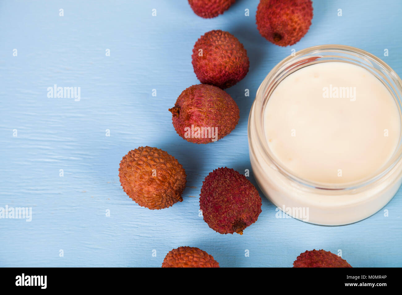 Yoghurt with lychee on a wooden background. Tasty breakfast. Healthy ...