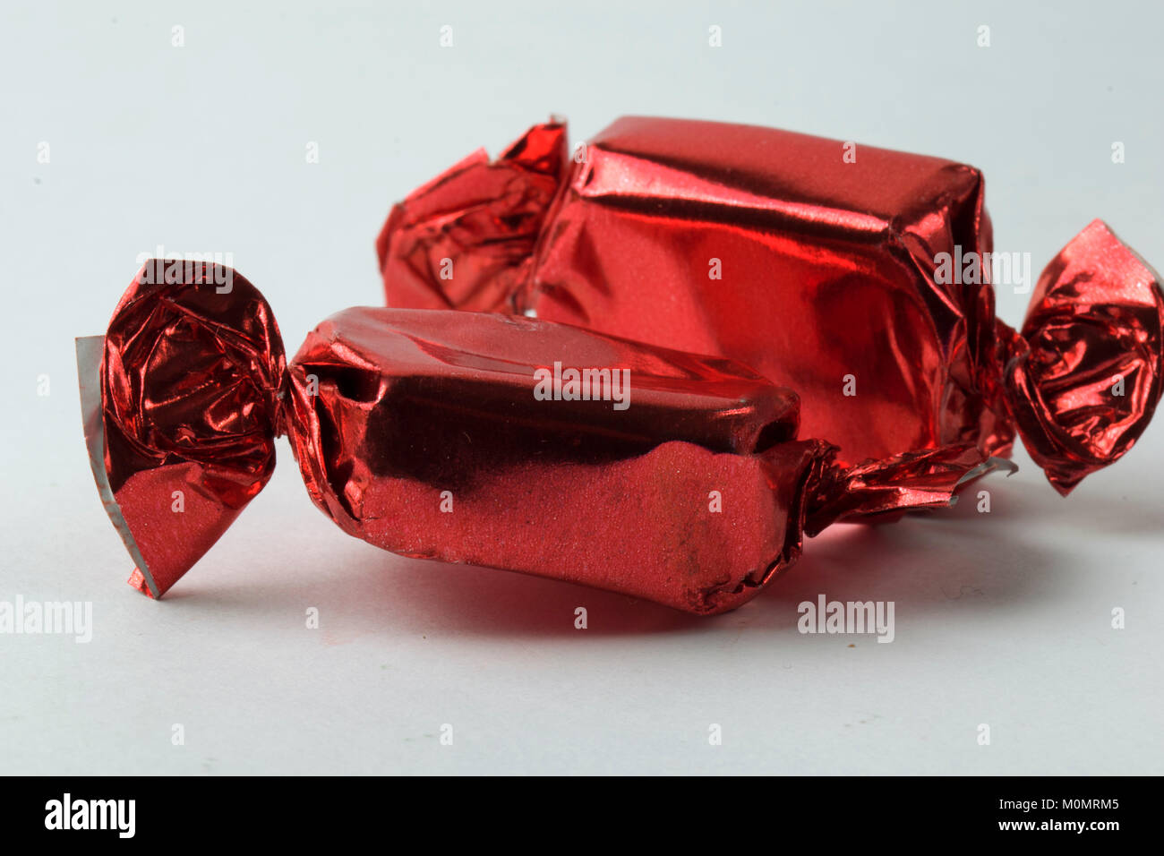 Square sweets in red wrapper isolated on wite background Stock Photo ...