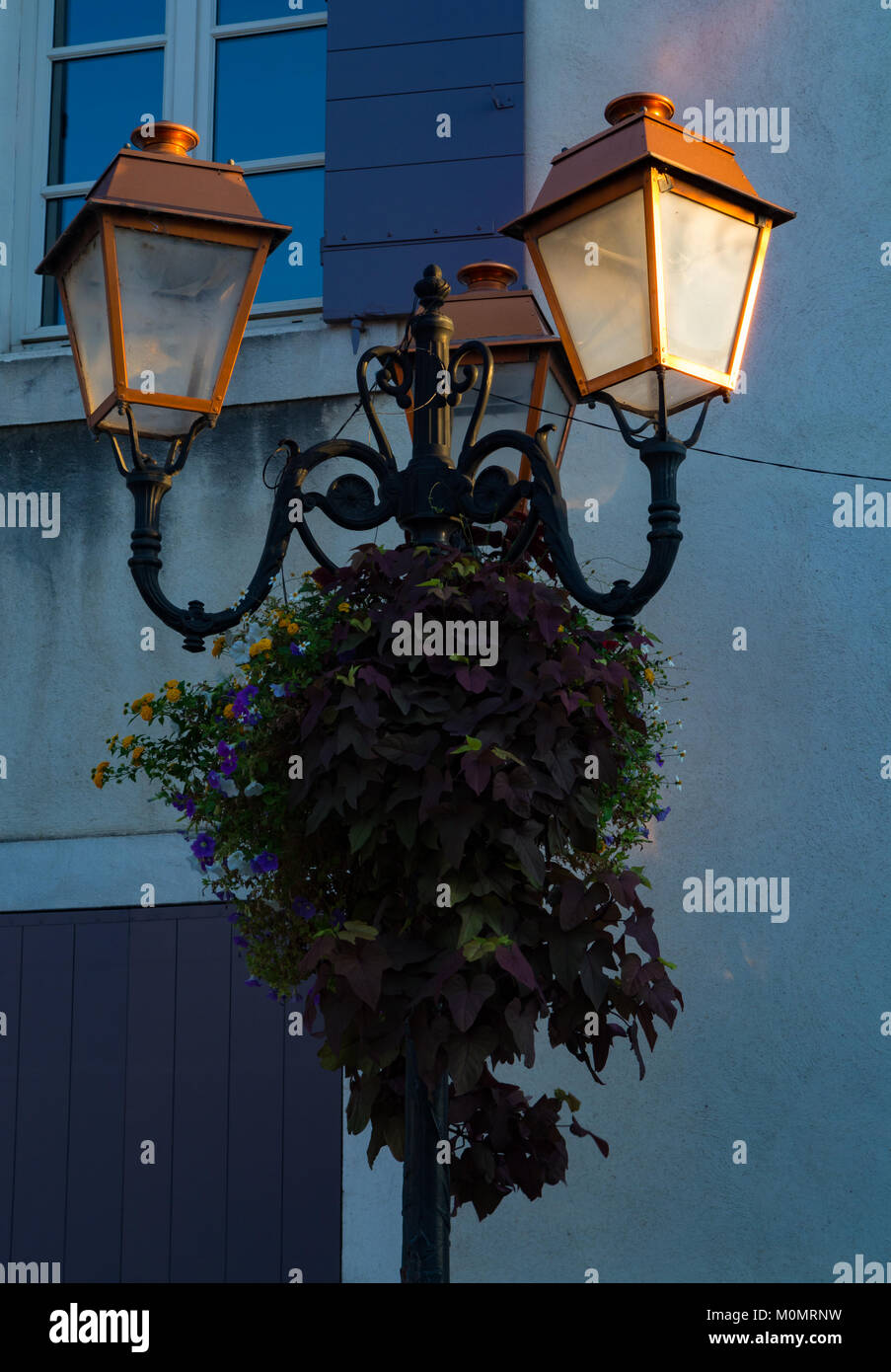 French style old vintage iron with glass street light in small village ...