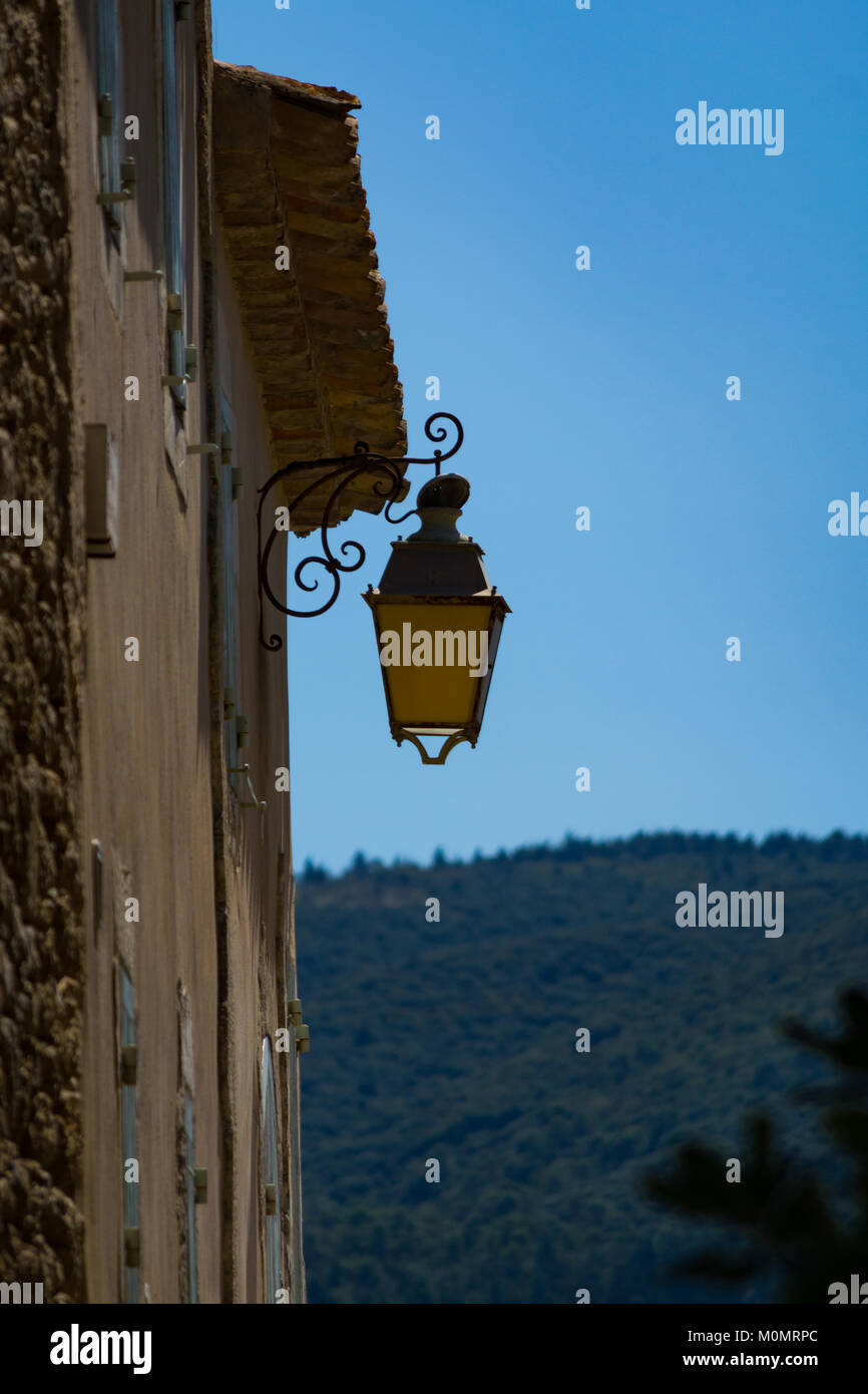 French style old vintage iron with glass street light in small village ...