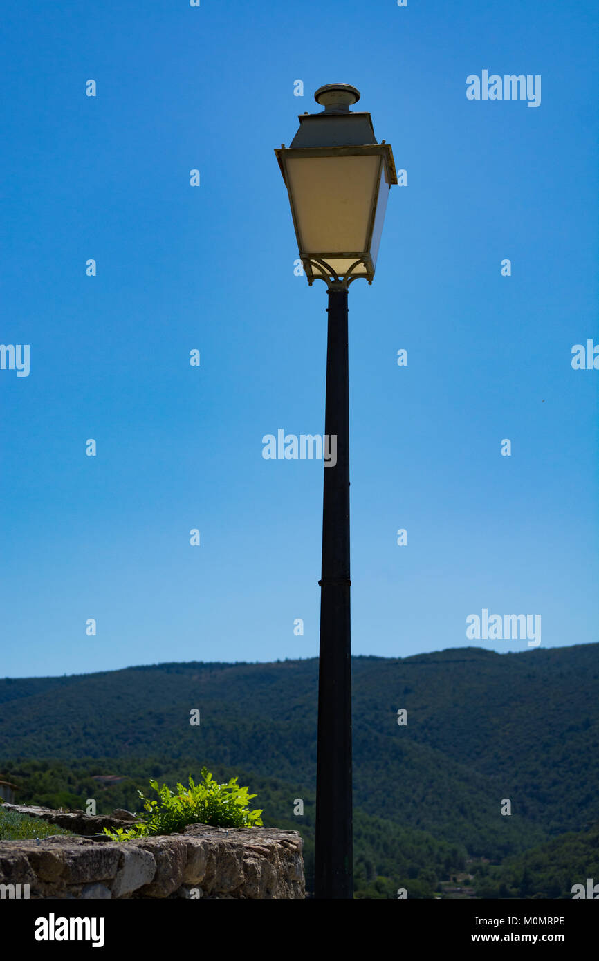 French style old vintage iron with glass street light in small village ...