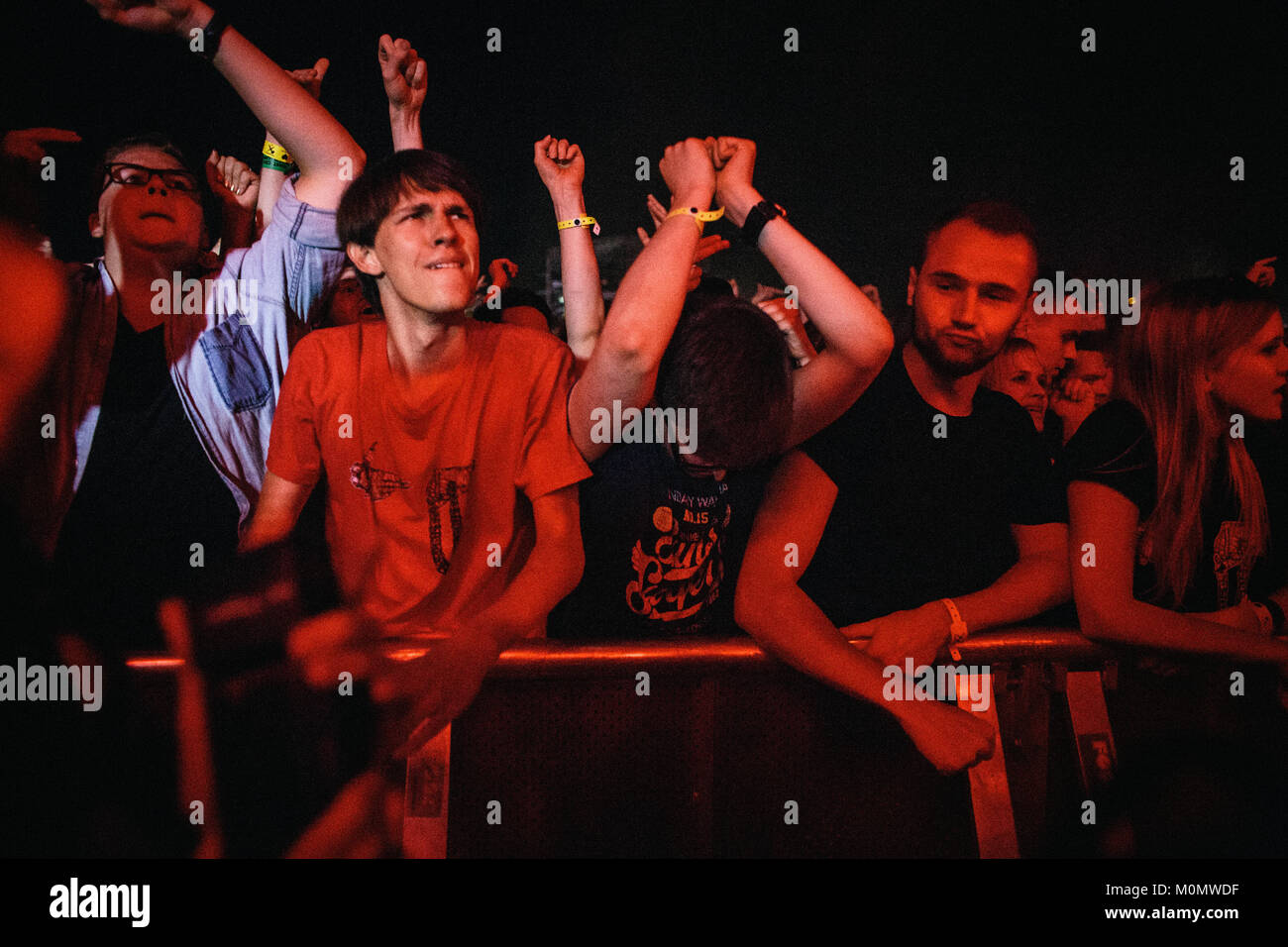 Energetic festival goers and music fans go crazy at a live concert with ...