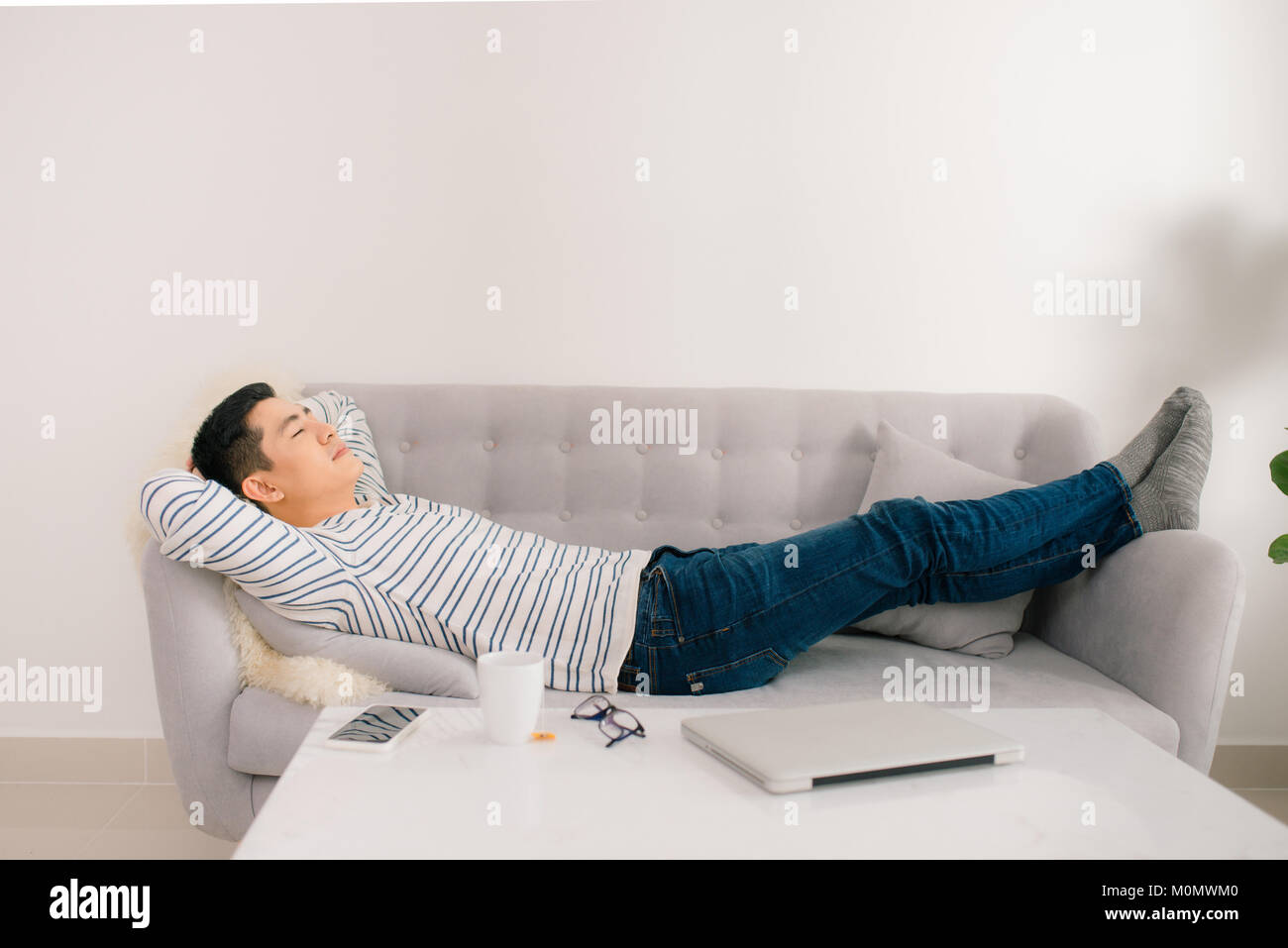 Man sleeping on sofa hi-res stock photography and images - Alamy